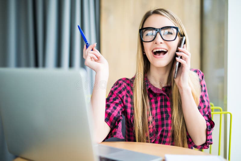 Pretty Young Woman Sitting at Her Workplace, Using Her Laptop Computer ...