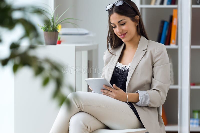 Pretty Young Woman Using Digital Tablet in the Office. Stock Photo ...