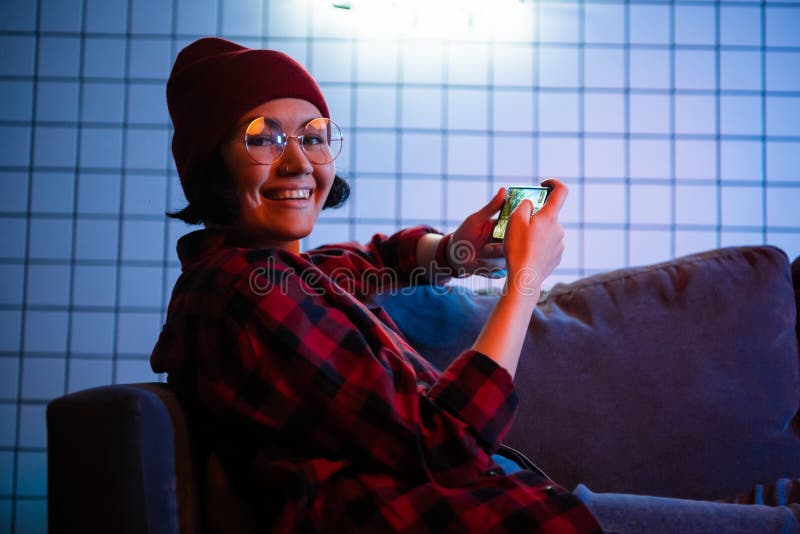 Pretty Young Woman Using Mobile Phone Playing Online Game at Home Stock ...