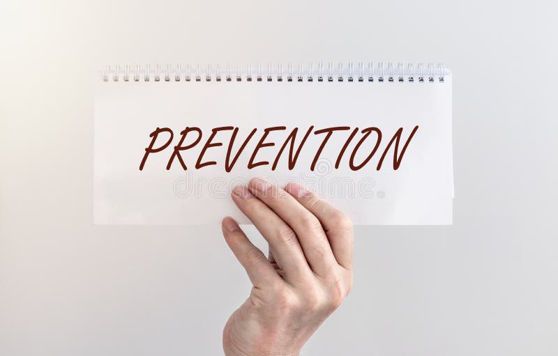 Prevention Word on White Paper in Male Hand Over White Wall Stock Photo ...