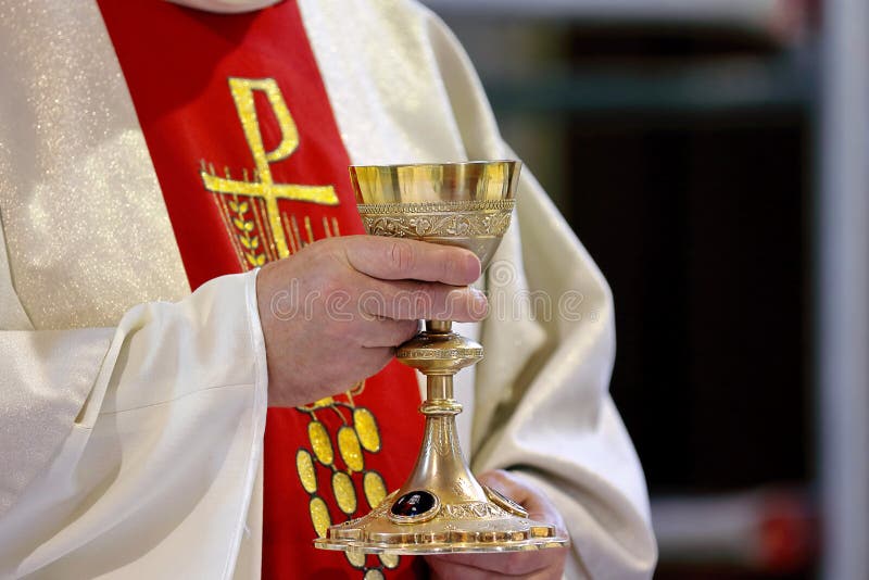Priest Holds the Chalice while Celebrating the Mass and Empty Space for ...