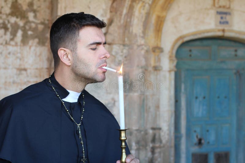 Priest Lighting a Cigarette with a Candle Stock Photo - Image of ...