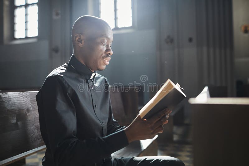 Priest reading the Bible stock photo. Image of relaxation - 217102302