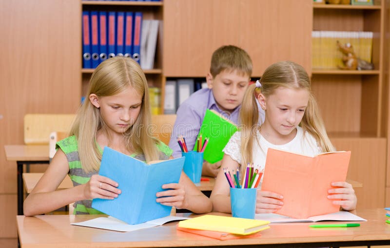 Primary School Children in the Classroom Reading Books Stock Photo ...
