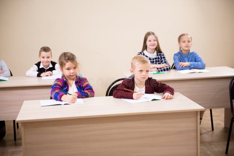 Primary School Children Work Together in Class. Stock Photo - Image of ...