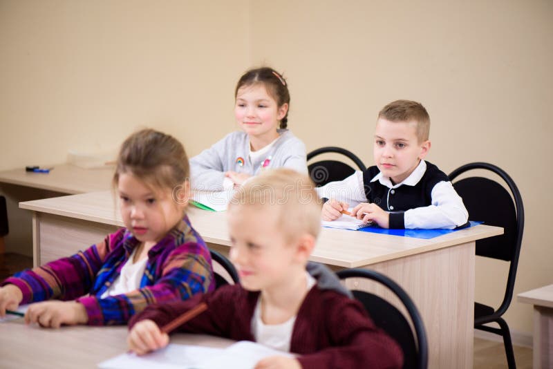 Primary School Children Work Together in Class. Stock Photo - Image of ...
