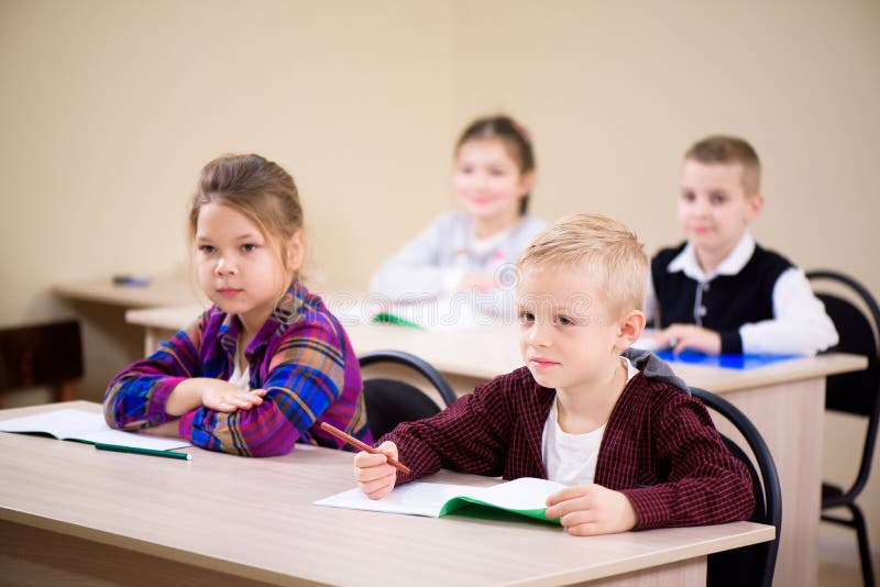 Primary School Children Work Together in Class. Stock Photo - Image of ...