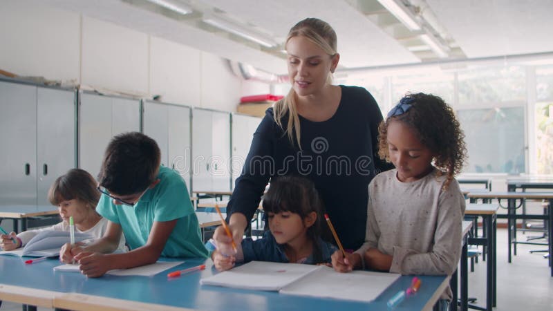 Primary School Teacher Checking Task Stock Video - Video of people ...