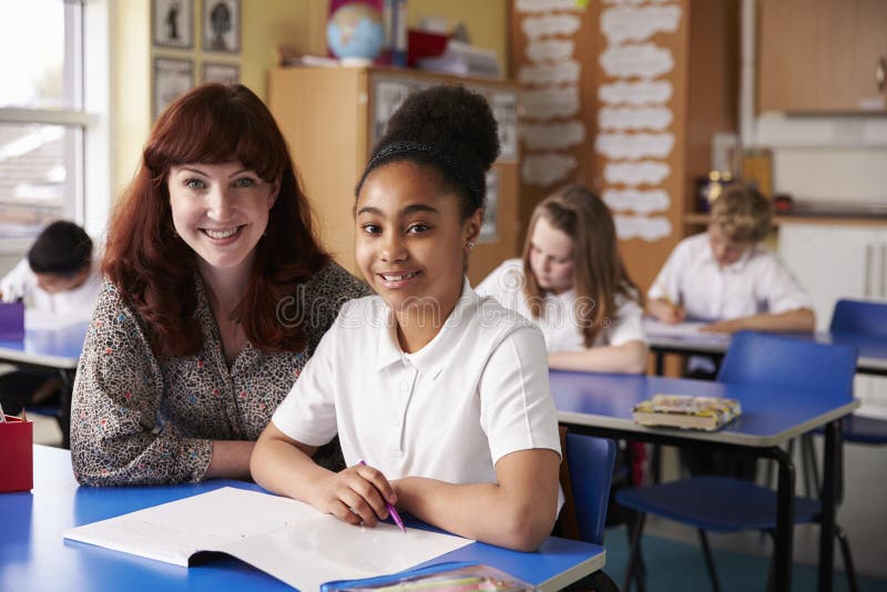 Primary School Teacher and Girl in Class Looking To Camera Stock Photo ...