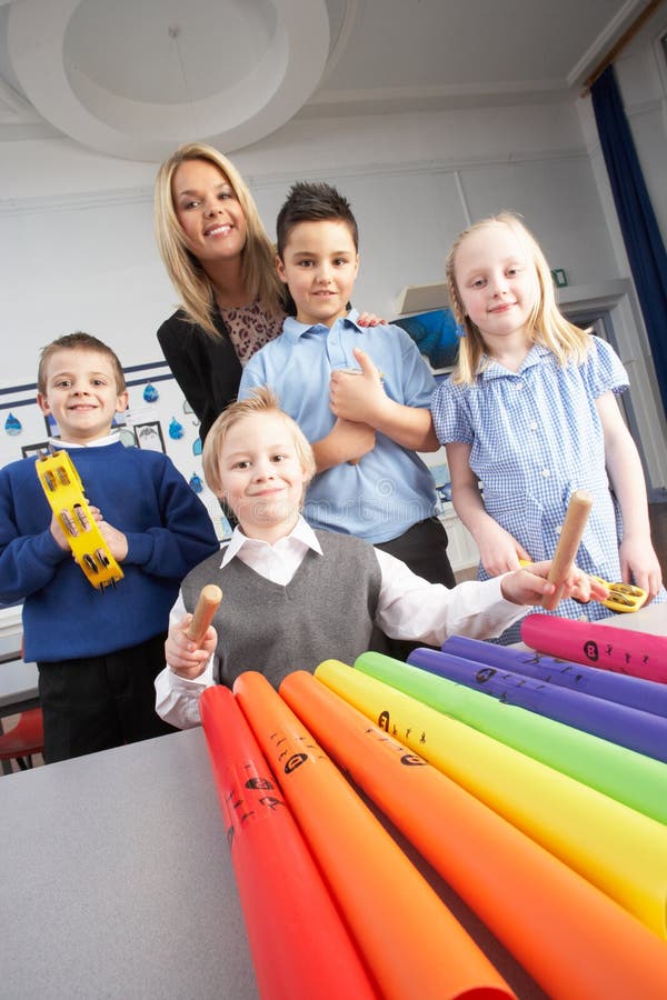 Primary Schoolchildren and Teacher Having a Lesson Stock Image - Image ...