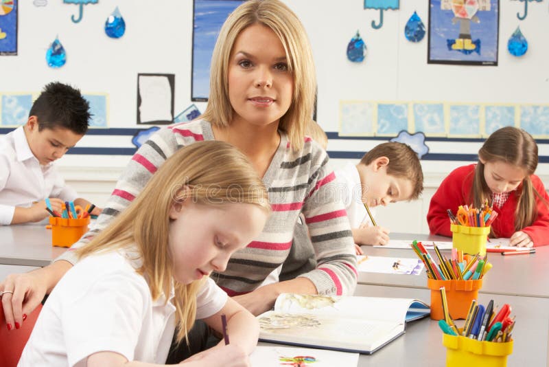 Primary Schoolchildren and Teacher Having a Lesson Stock Image - Image ...