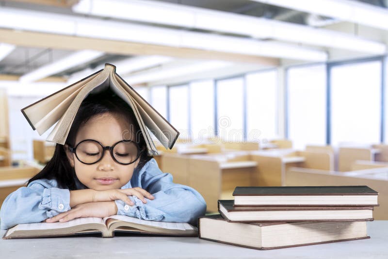 Primary Student Reading Textbook in Classroom Stock Photo - Image of ...