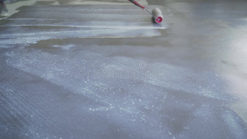 Priming the Floor with a Roller. Priming Concrete Floor before Laying ...
