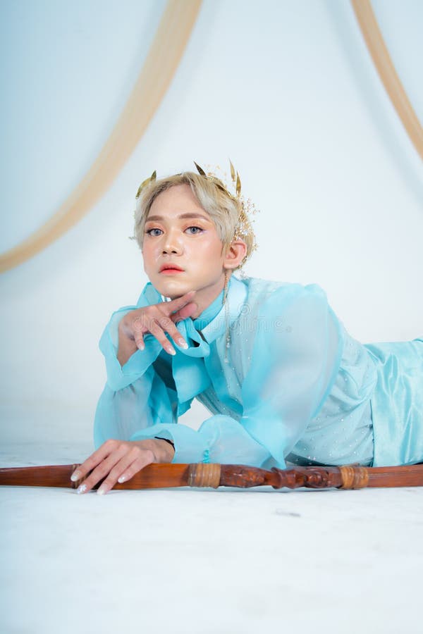 A Princess in a Blue Dress Posing on the Floor with a Bow Stock Image ...