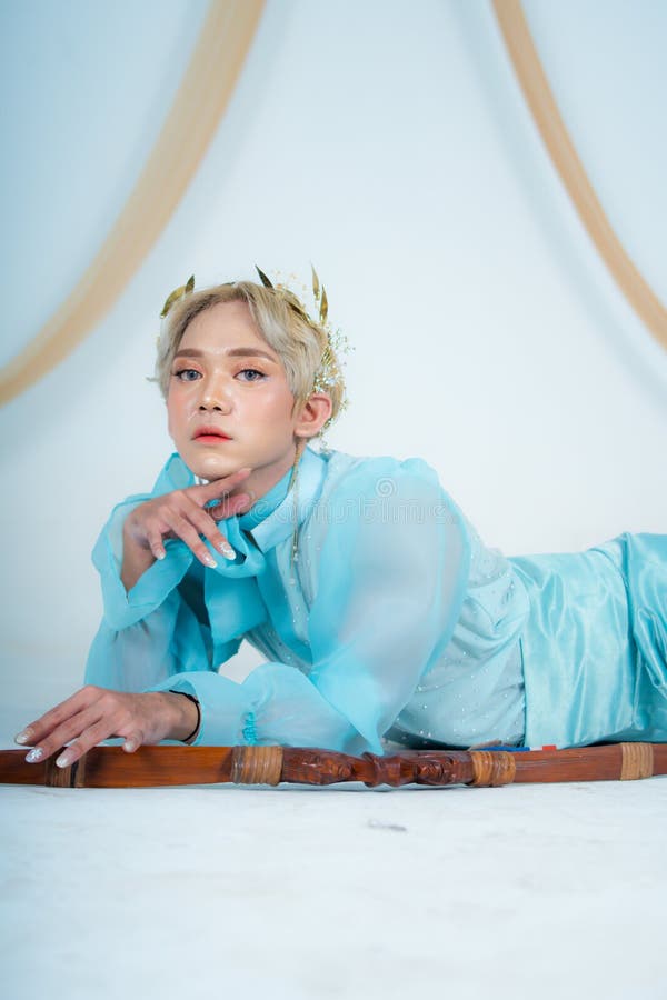 A Princess in a Blue Dress Posing on the Floor with a Bow Stock Photo ...