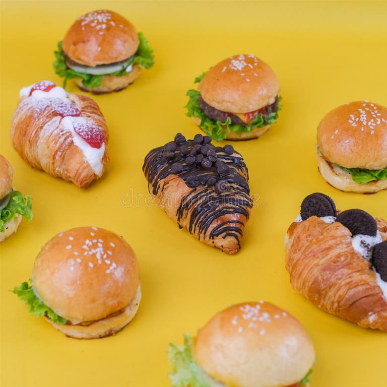 Assorted Mini Croissant and Burger Isolated on Yellow Background Stock ...