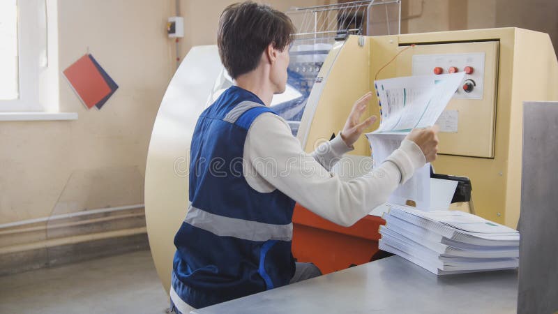 The Print Operator Puts a Sheet of Paper Stock Photo - Image of ...