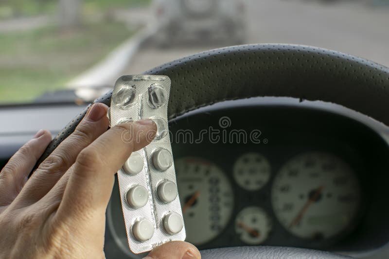 A Printed Package of Pills in the Hand of a Sick Driver Inside the Car ...