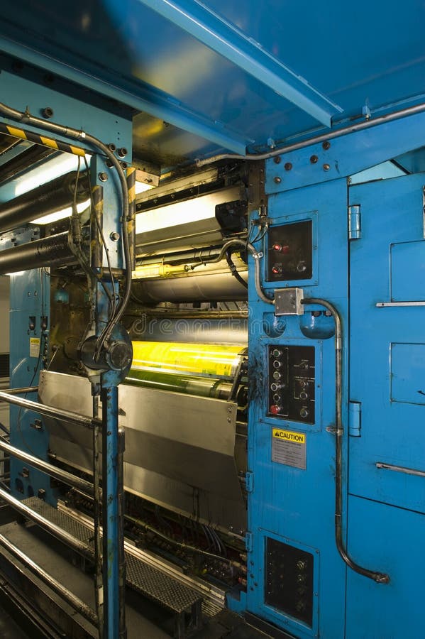 Man Working in Printing Press between Two Cash Register Machine Stock ...