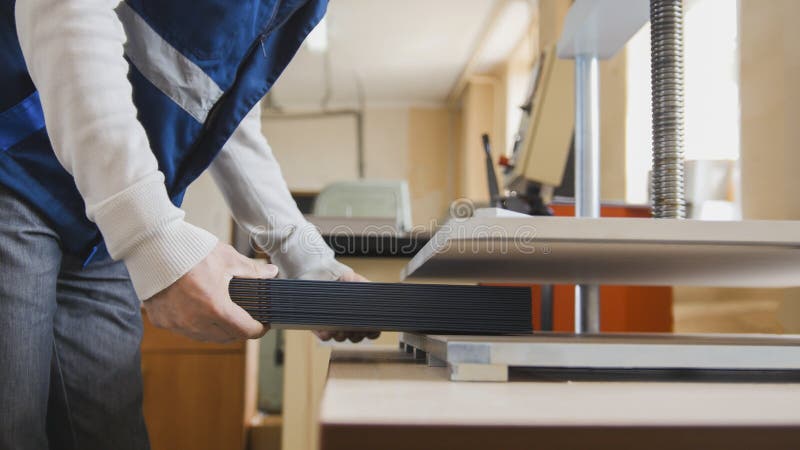 Printing Process in Printing Press Machine - Worker Inserts Paper ...