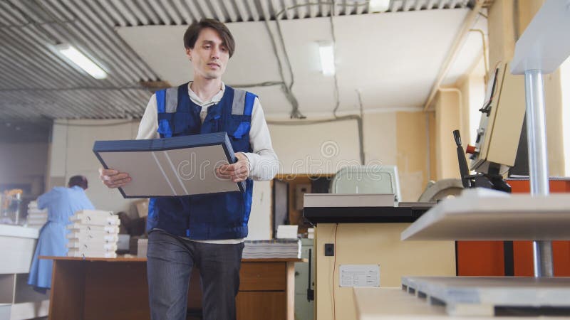 Printing Process - Worker Inserts Paper Sheets Stock Photo - Image of ...