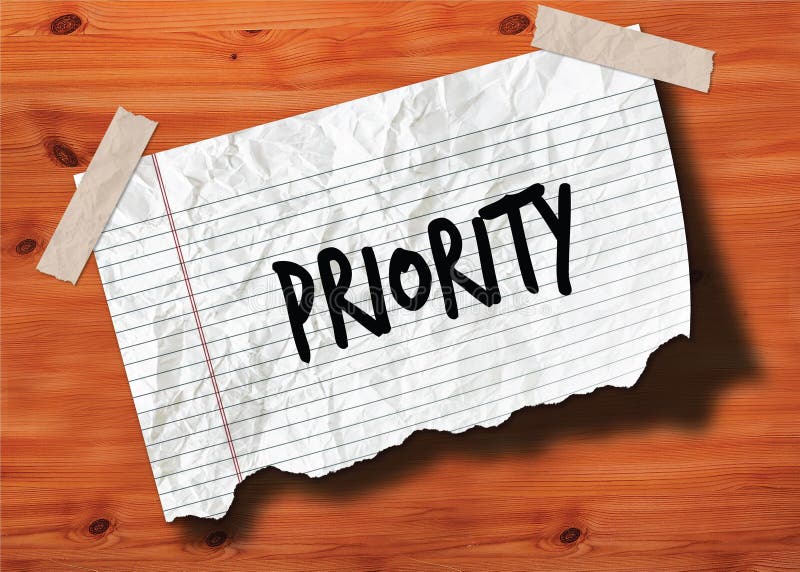 PRIORITY Handwritten on Torn Notebook Page Crumpled Paper on Wood ...