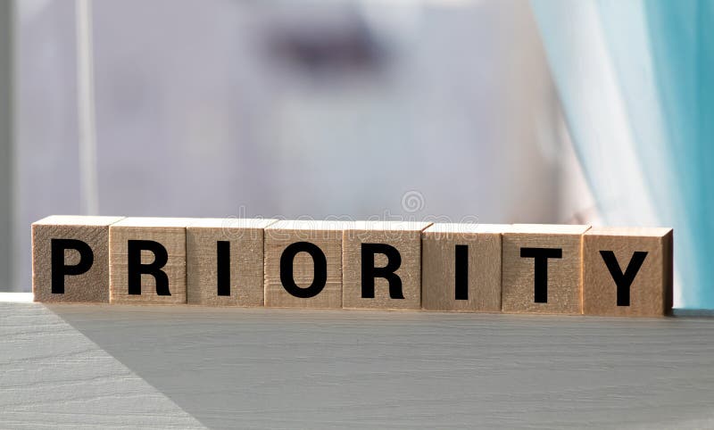 Priority Word Written on Wood Block. Priority Text on Table, Concept ...