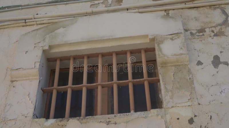 Prison Building Wall with Barred Windows of Prison Cells Behind an Iron ...