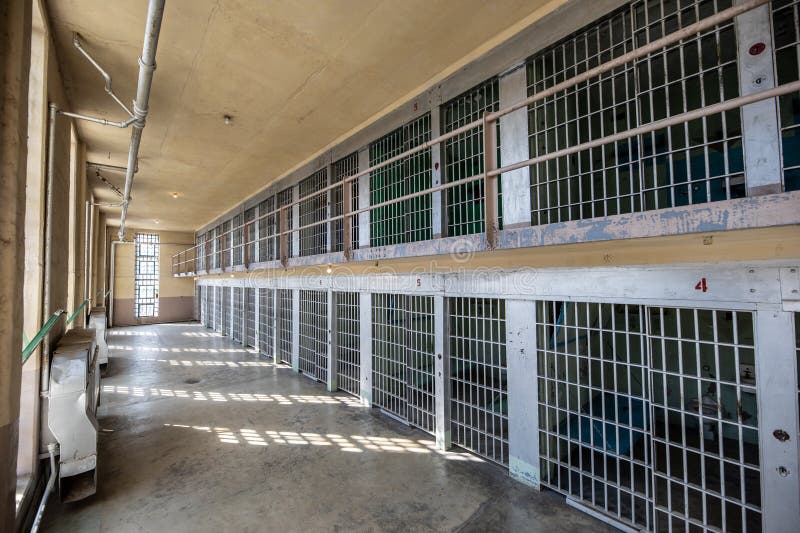 A Prison Cell Block with Many Cells and a Long Hallway Stock Image ...