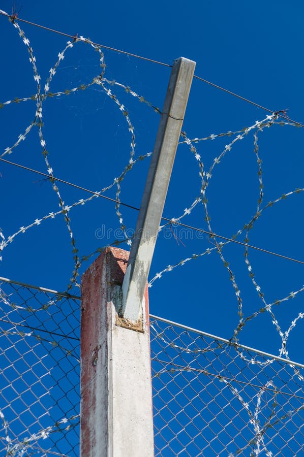 Prison Concrete Pillar and Barbed Wire Fence Stock Photo - Image of ...