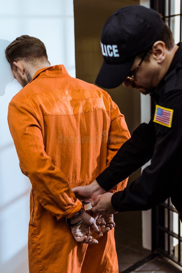 Prison Guard Wearing Handcuffs Stock Image - Image of closing, inmate ...