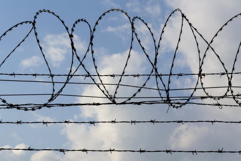 Prison Wall Barbed Wire Fence with Blue Sky in Background Stock Image ...