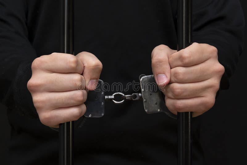 Prisoner Man in Handcuffs Squeezing the Bars, Dark Tone, Selective ...