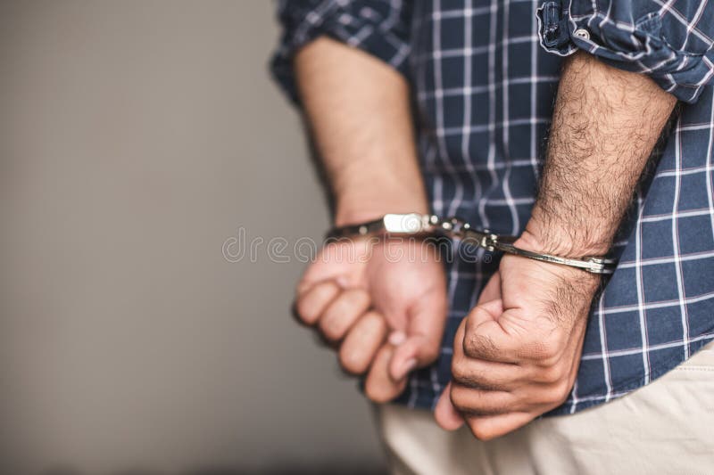 Prisoner Man in Jail with Handcuffs. Close Up Shackled in Hands Stock ...
