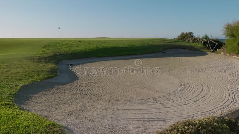 Pristine Golf Course Bunker with Raked Sand Patterns Under Clear Skies ...