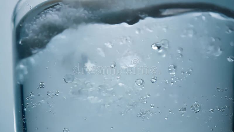 Pristine Sparkling Water Cascading into Transparent Glass, Generating ...