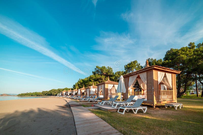 Private Beach Cabanas on a Serene Sandy Shoreline at Sunset Stock Image ...