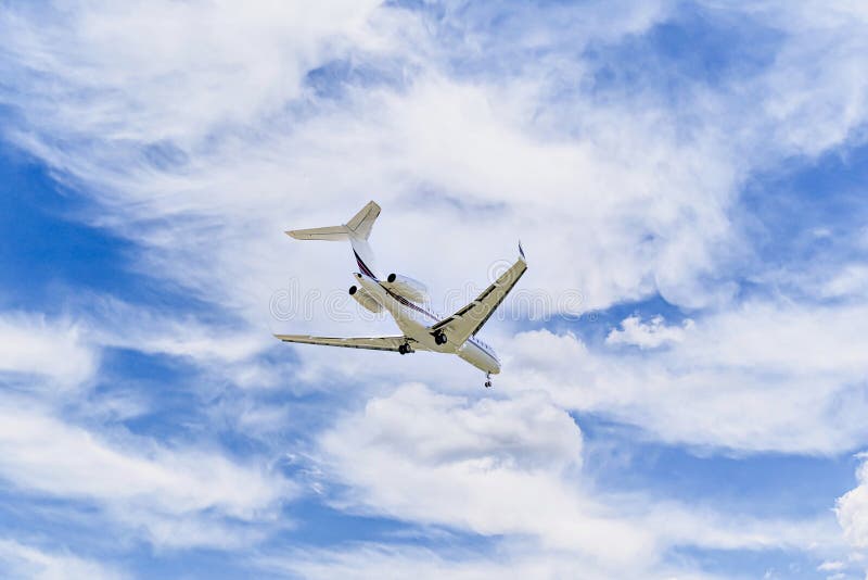 Private Business Jet Flying Under a Blue Sky Stock Photo - Image of ...