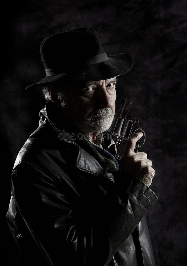 A Private Detective with a Revolver in Front of a Black Backdrop Stock ...