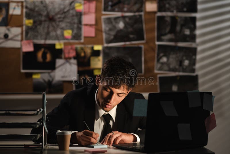 Private Detective Working at Desk in His Office, Processing Evidence ...