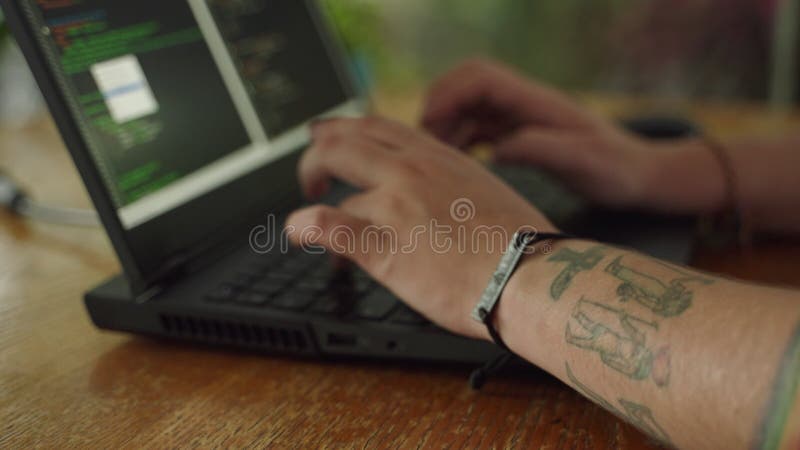 Tattooed Programmer Types Code on Laptop, Debugging Software Project ...