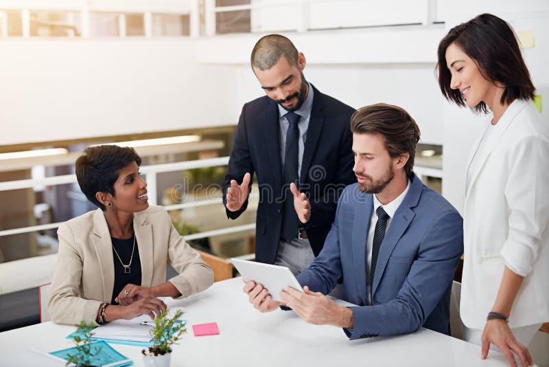 Problem Solving As a Team. Businesspeople Using a Digital Tablet in an ...