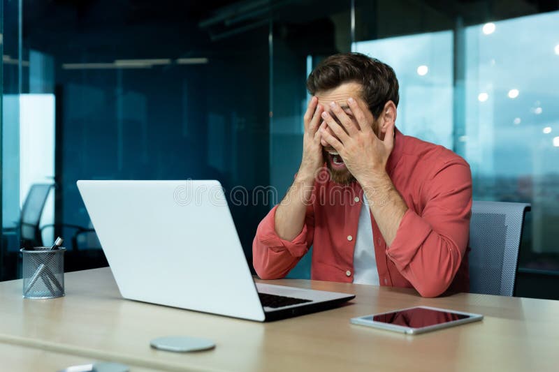 Problems at Work. a Young Man Sits in the Office at a Table with a ...