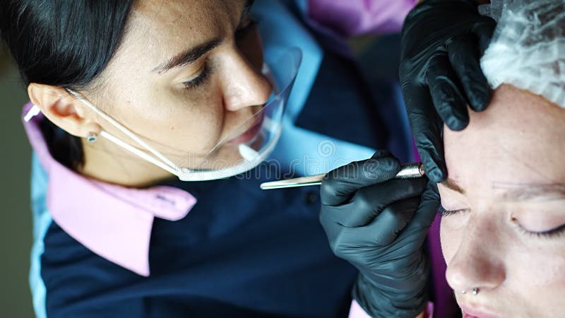 Procedure of Eyebrow Microblading. a Master in Black Gloves is Doing a ...