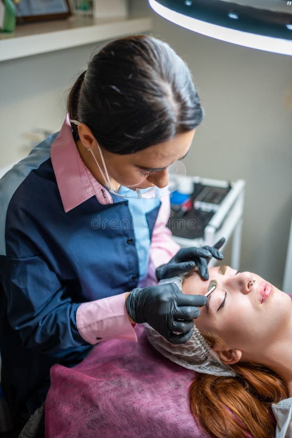 Procedure of Eyebrow Microblading. a Master in Black Gloves is Doing a ...