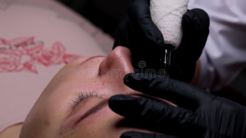 The Procedure of Eyebrow Tattooing is Performed by a Master Using a ...