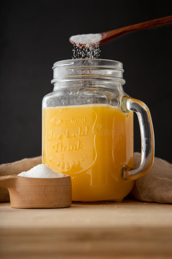 Process of Adding Honey into Orange Juice in a Beverage Mason Container ...
