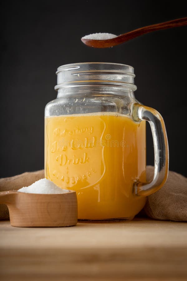 Process of Adding Sugar into Orange Juice in a Beverage Mason Container ...