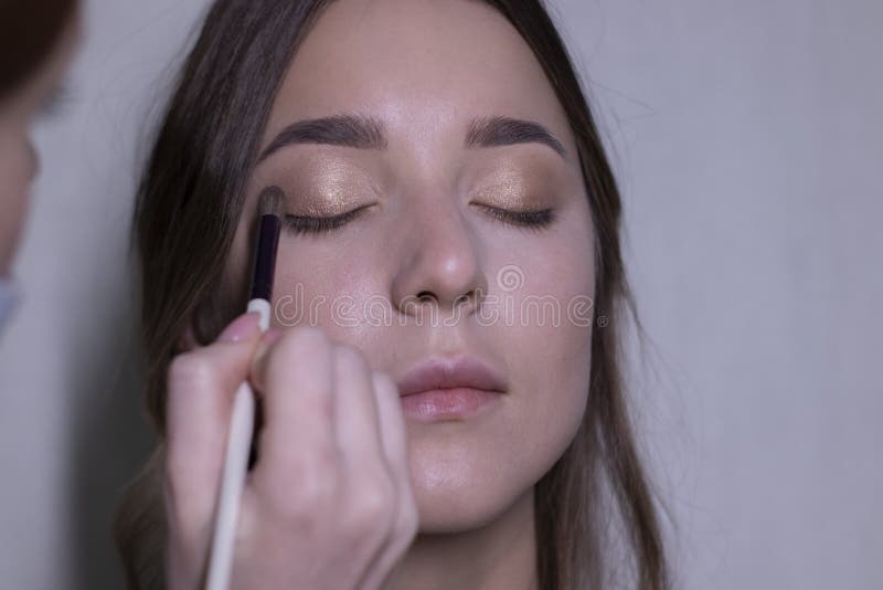 The Process of Applying Makeup To a Beautiful Brunette. Beauty ...