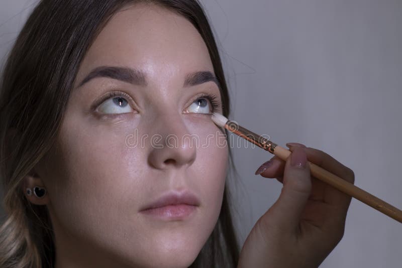 The Process of Applying Makeup To a Beautiful Brunette. Beauty ...